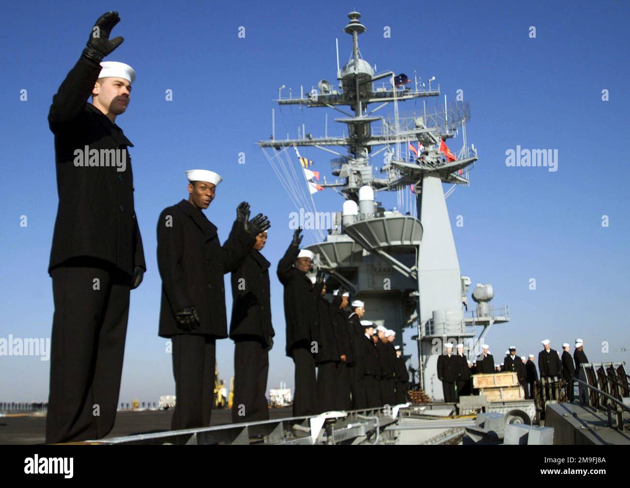 Crewmembers of the USS HARRY S. TRUMAN (CVN 75) wave goodbye to friends ...