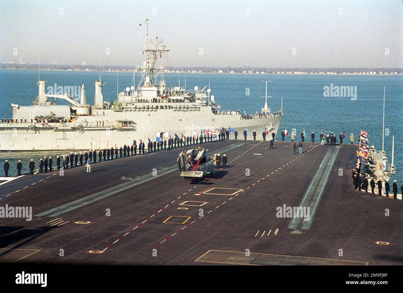 USS Nashville (LPD 13) passes by the bow of the USS Harry S. Truman ...