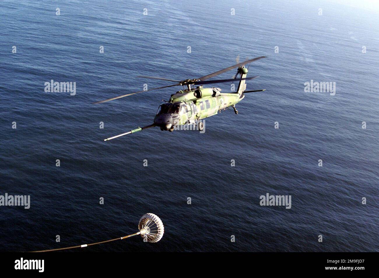 An aerial left side view of an HH-60G Pavehawk helicopter from the ...