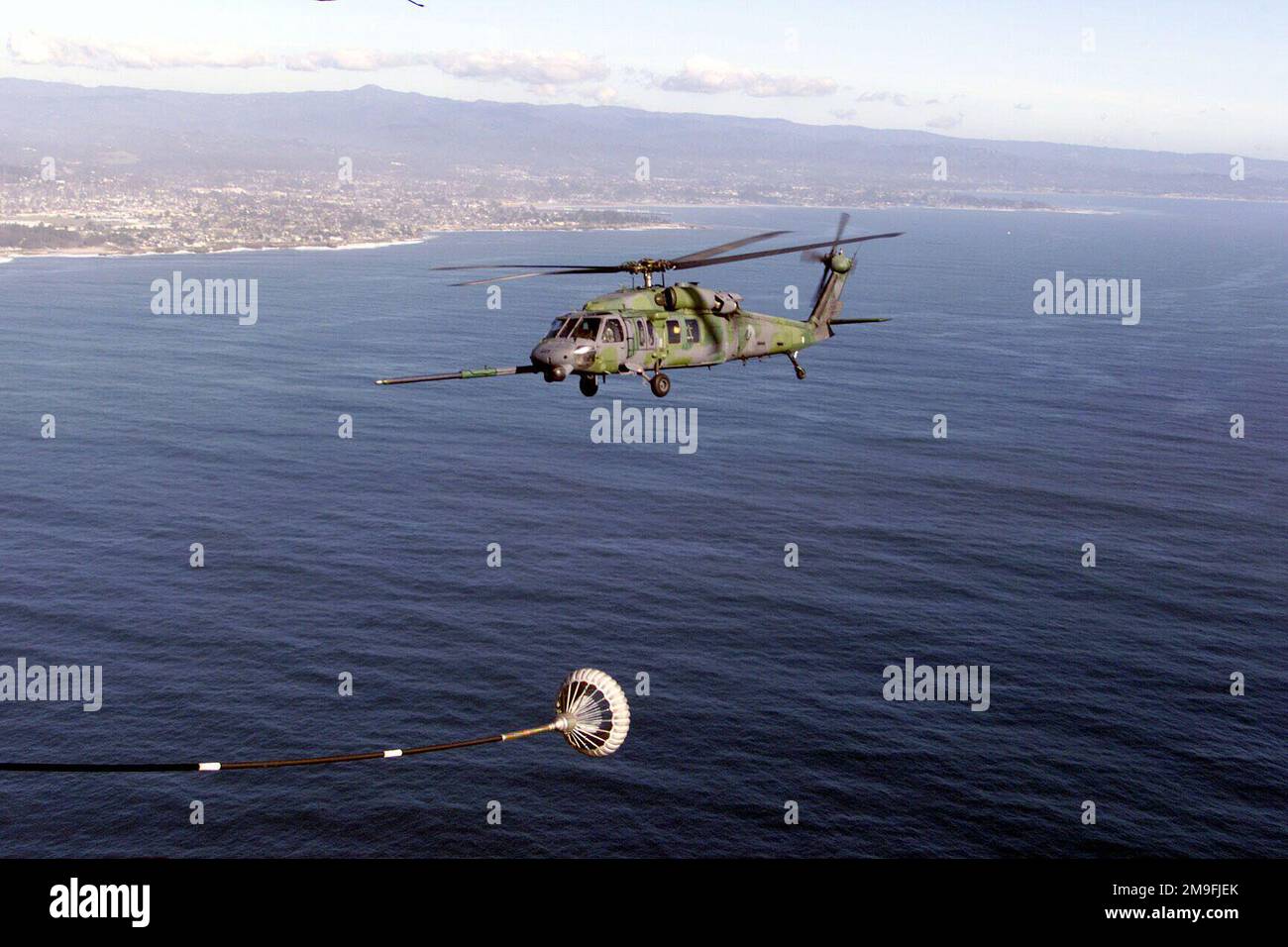 An air to air left side view of an HH-60G Pavehawk helicopter from the ...