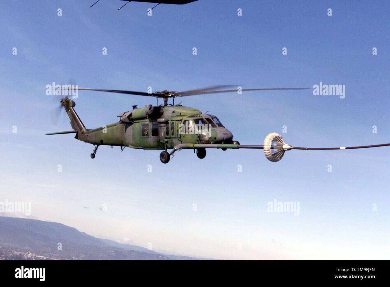 An air to air right side view of an HH-60G Pavehawk helicopter from the ...