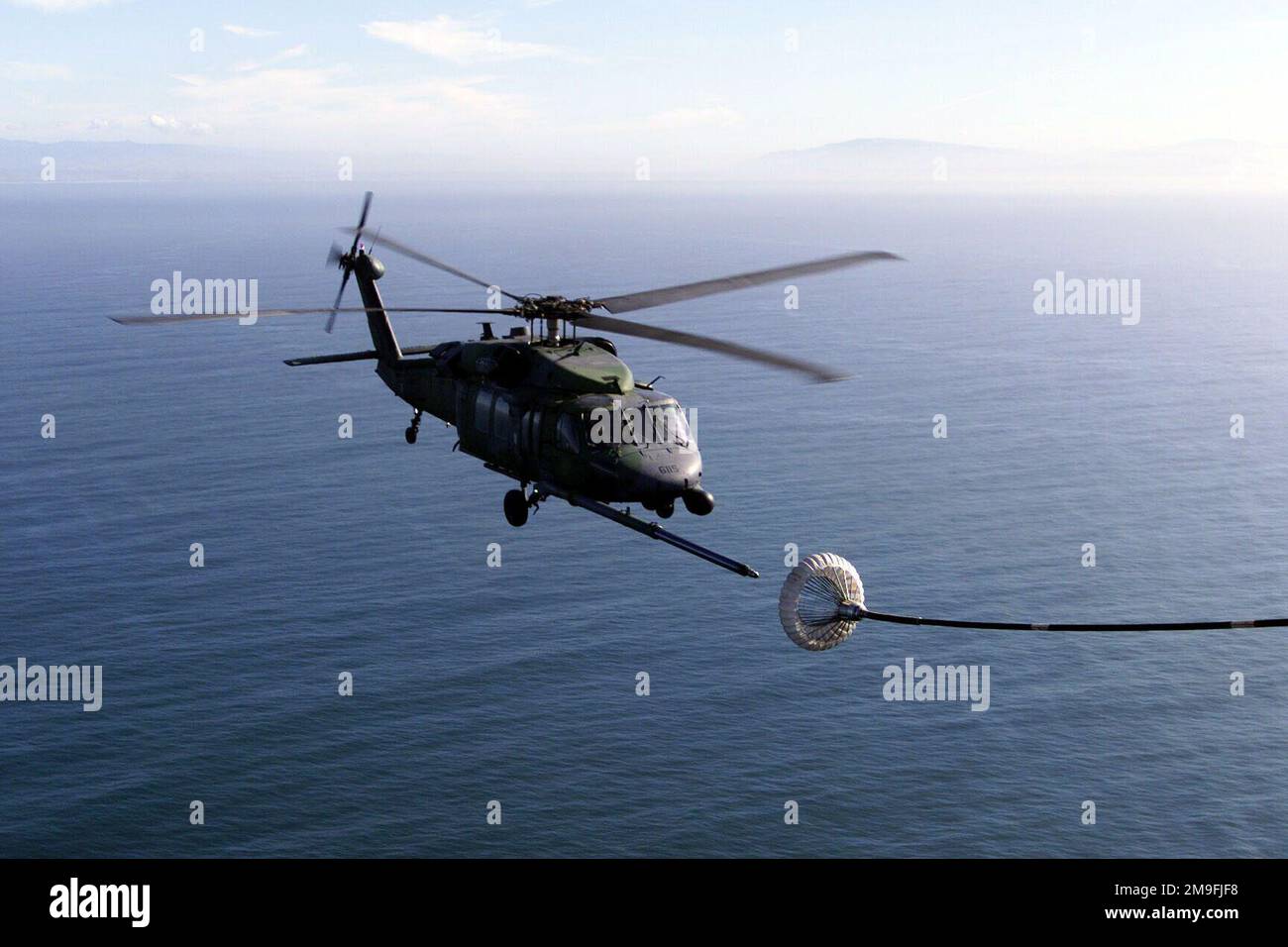 An air to air right side view of an HH-60G Pavehawk helicopter from the ...