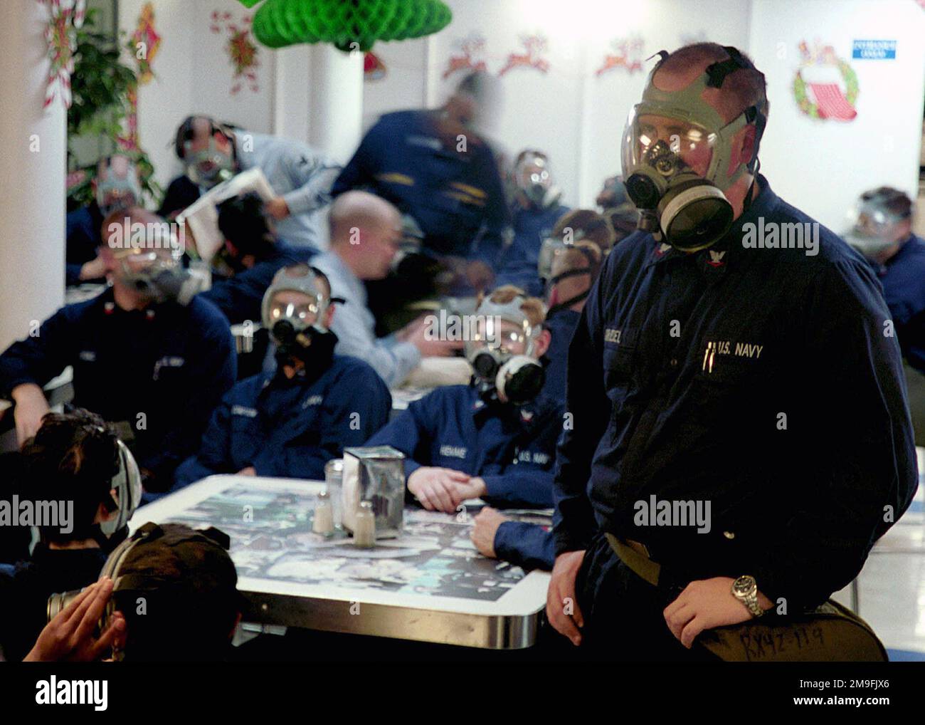 Machinist's Mate Third Class Jonathan Griesel dons an MCU/2-P Chemical ...