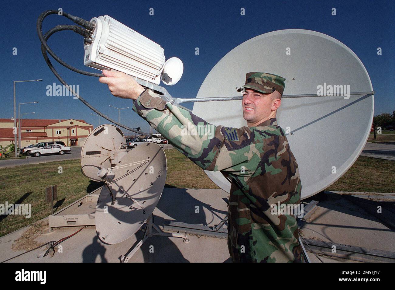 US Air Force STAFF Sergeant Greg Strong of the weather flight, adjusts ...