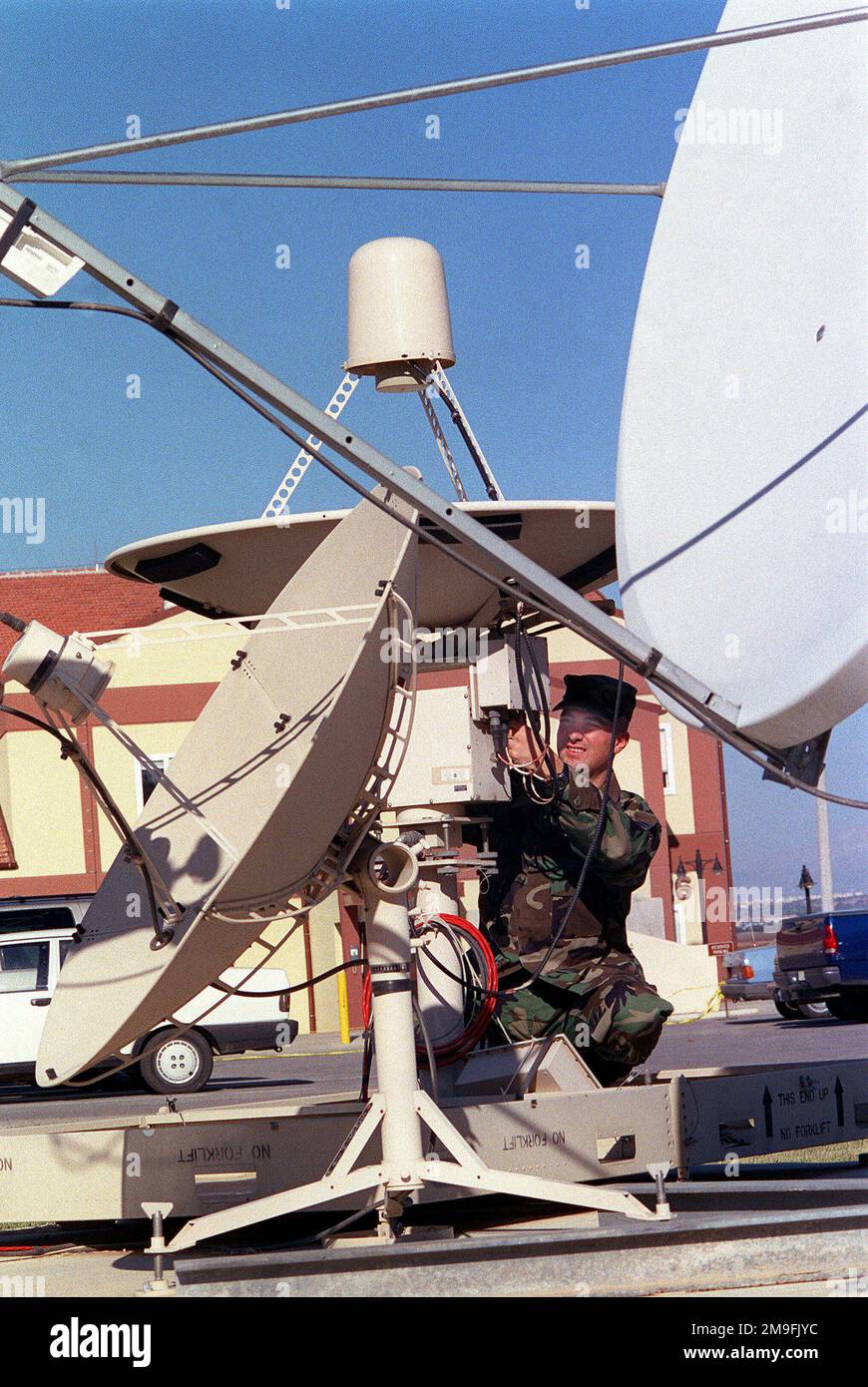 US Air Force STAFF Sergeant Greg Strong of the weather flight, adjusts ...