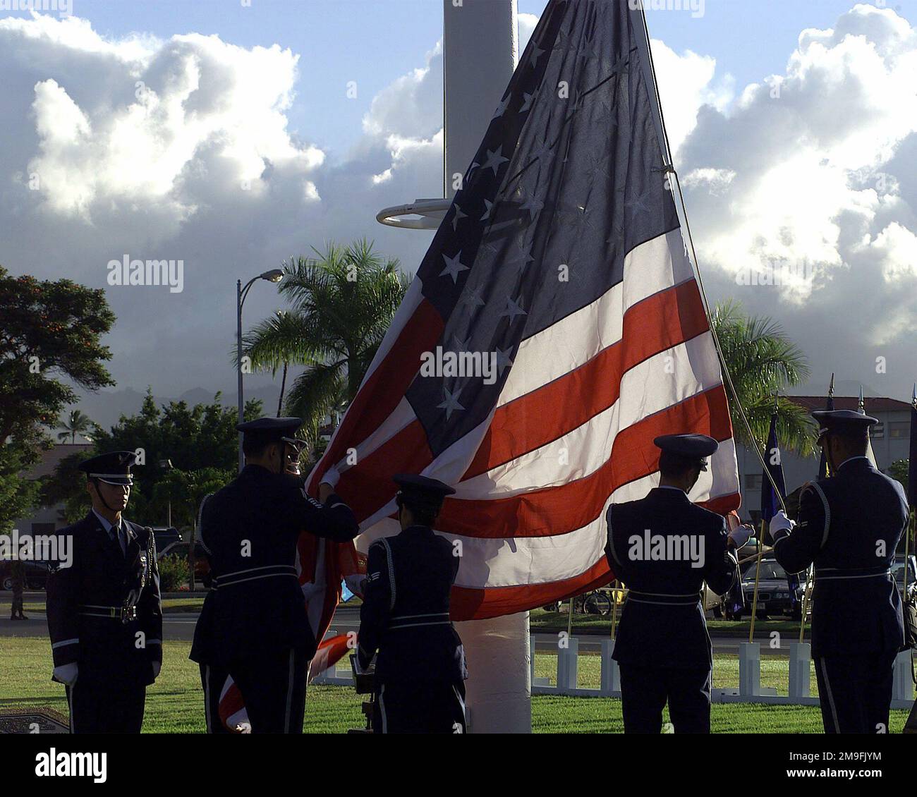 Hickam Air Force Base Honor Guard members raise the colors for the ...
