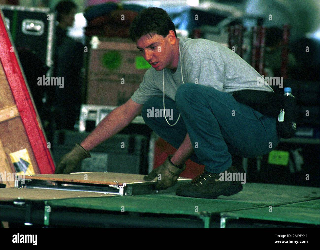 Todd Davis, a grip for FOX Sports, builds the stage for the NFL pre ...