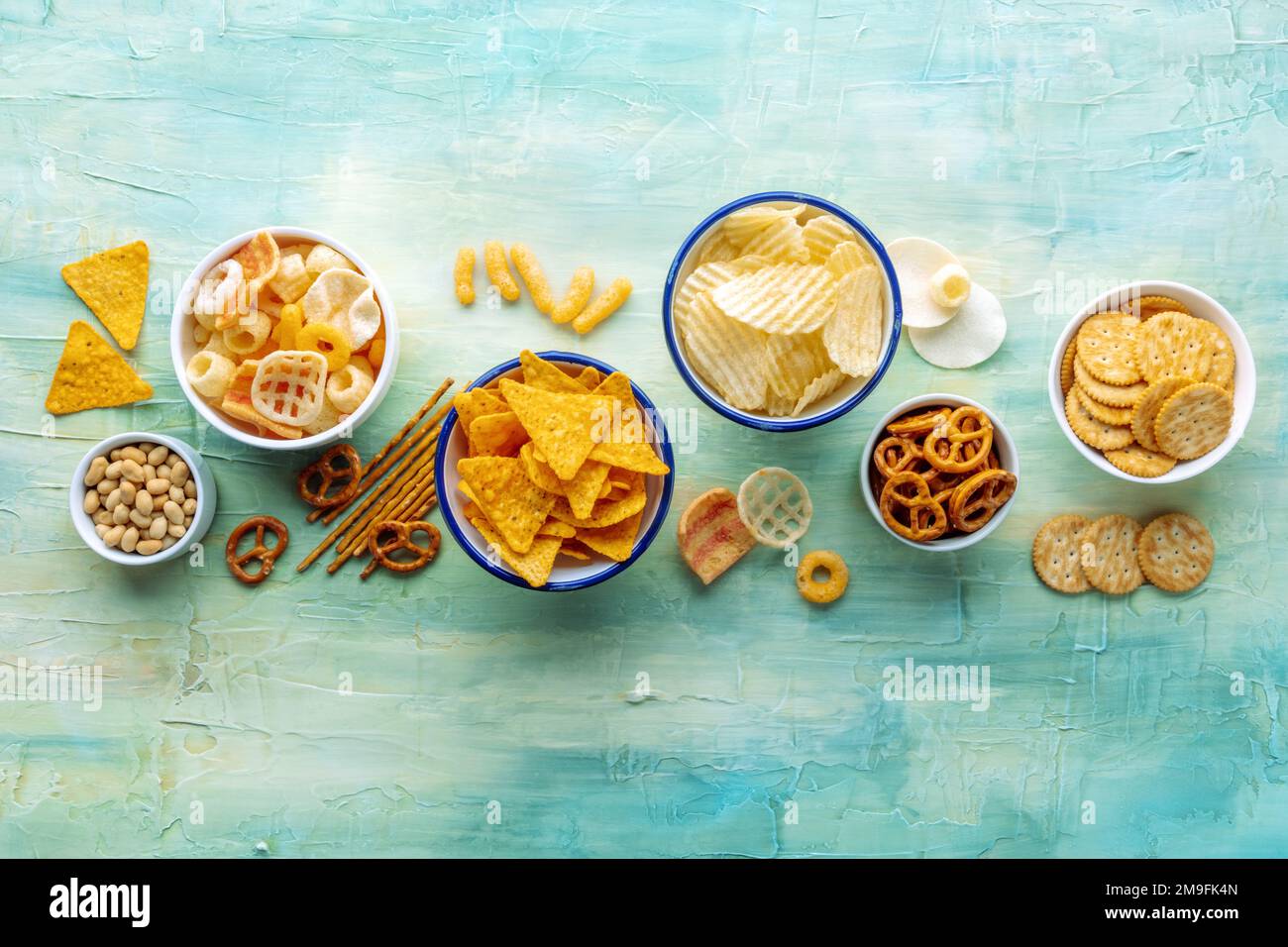 Salty snacks, overhead flat lay background with copy space. Party food ...