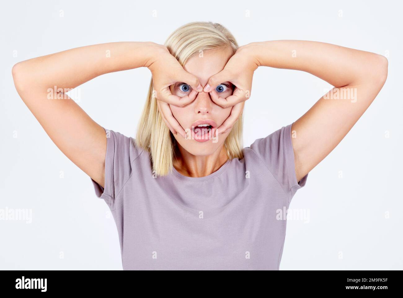 Young woman, silly and fingers glasses, happiness and girl isolated on ...