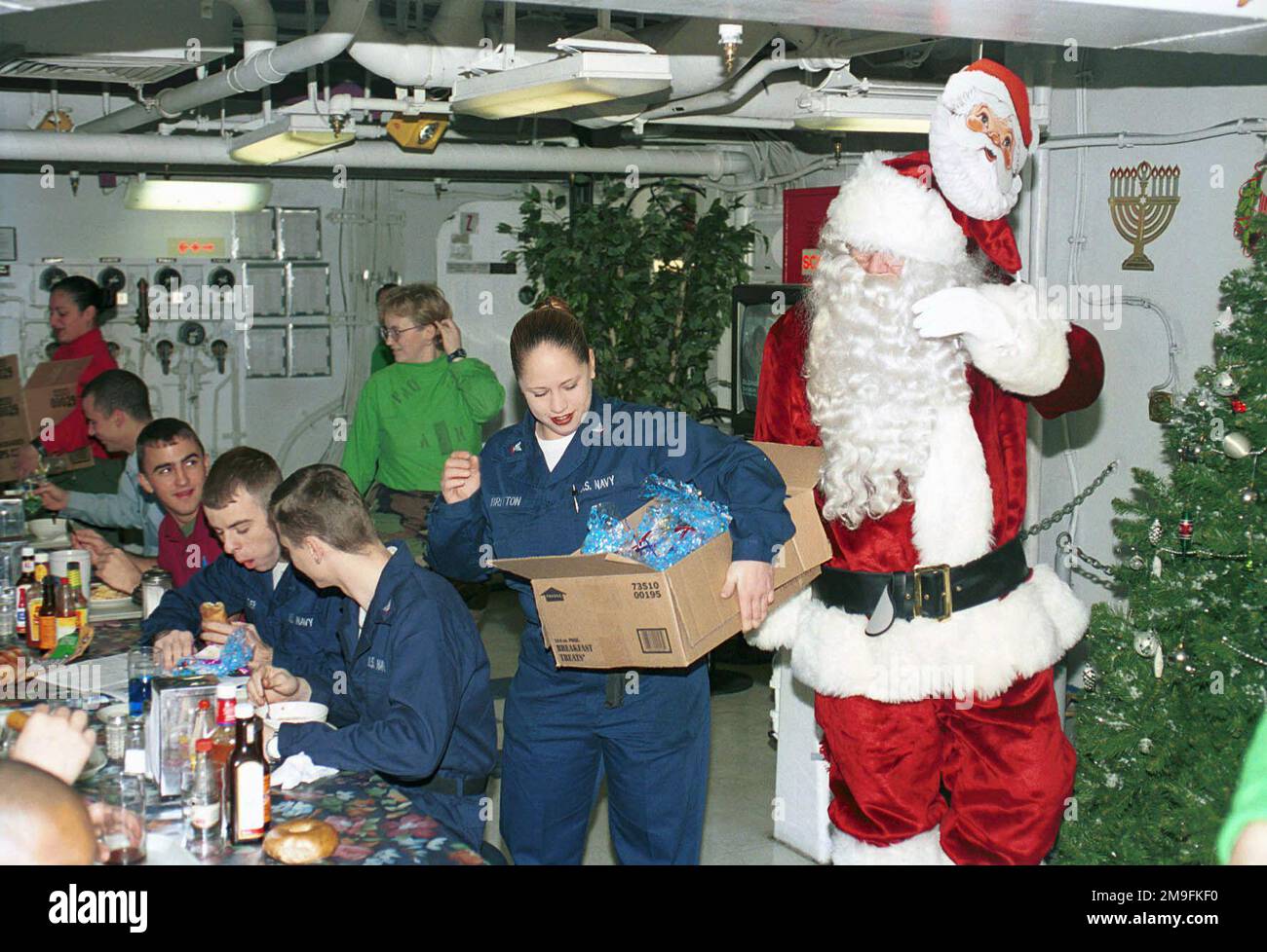 Santa Claus and his helper, US Navy Machinist Mate Third Class Tamera ...
