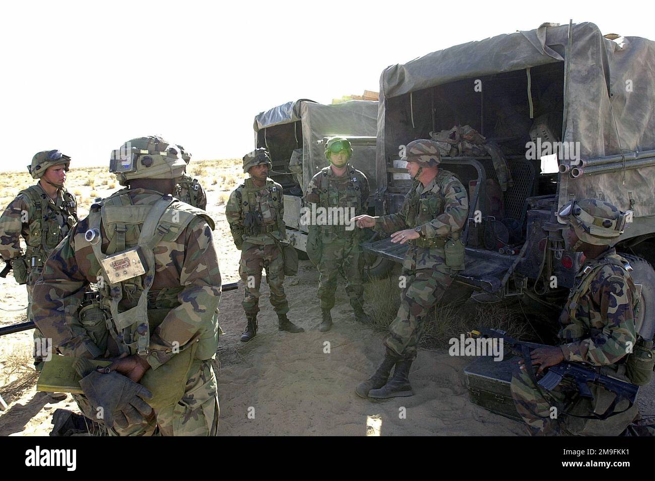 Leaning on the tailgate of an M1097 High-Mobility Multipurpose Wheeled ...
