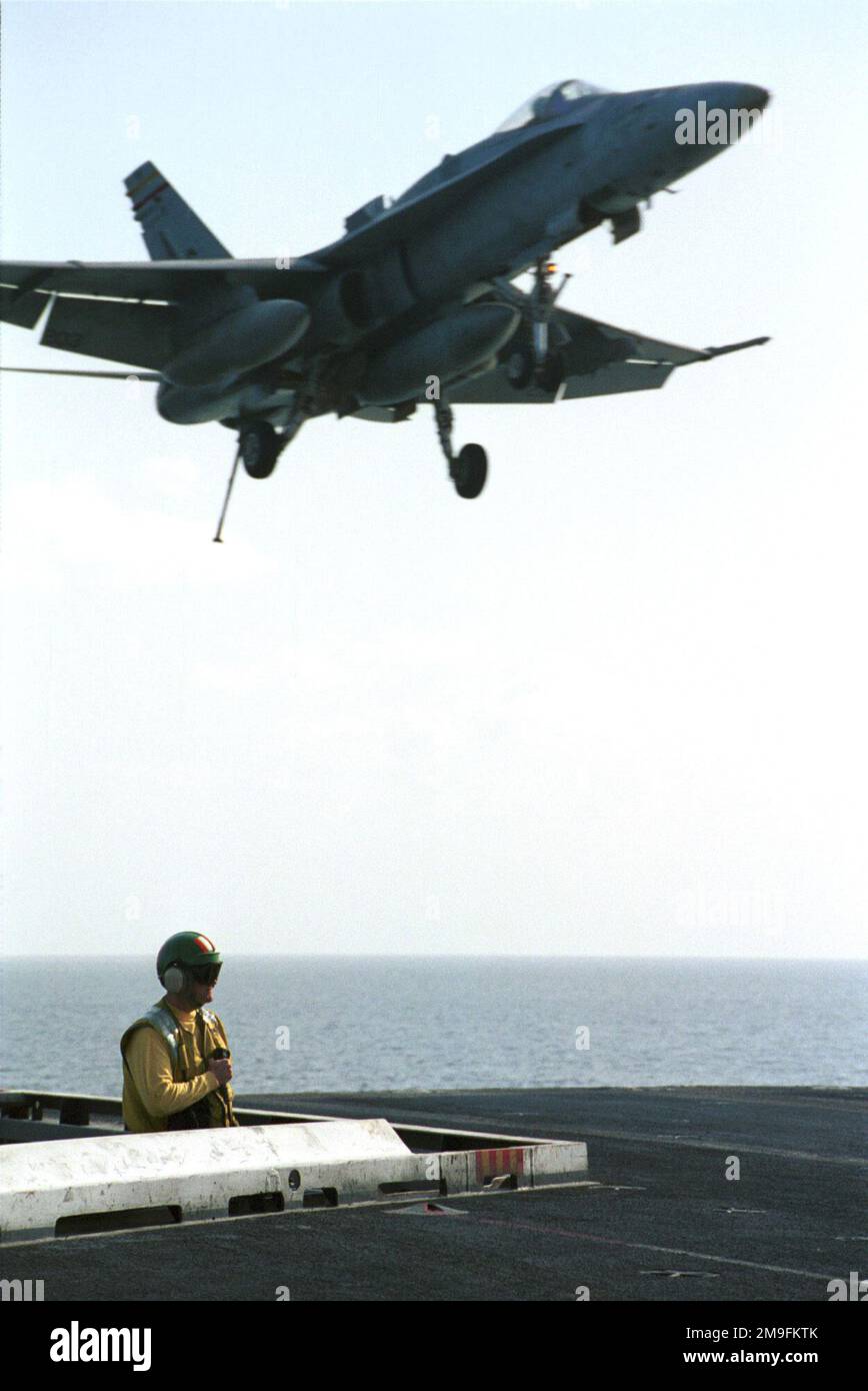 A USS HARRY S. TRUMAN (CVN 75) Flight Deck Officer surveys the landing ...