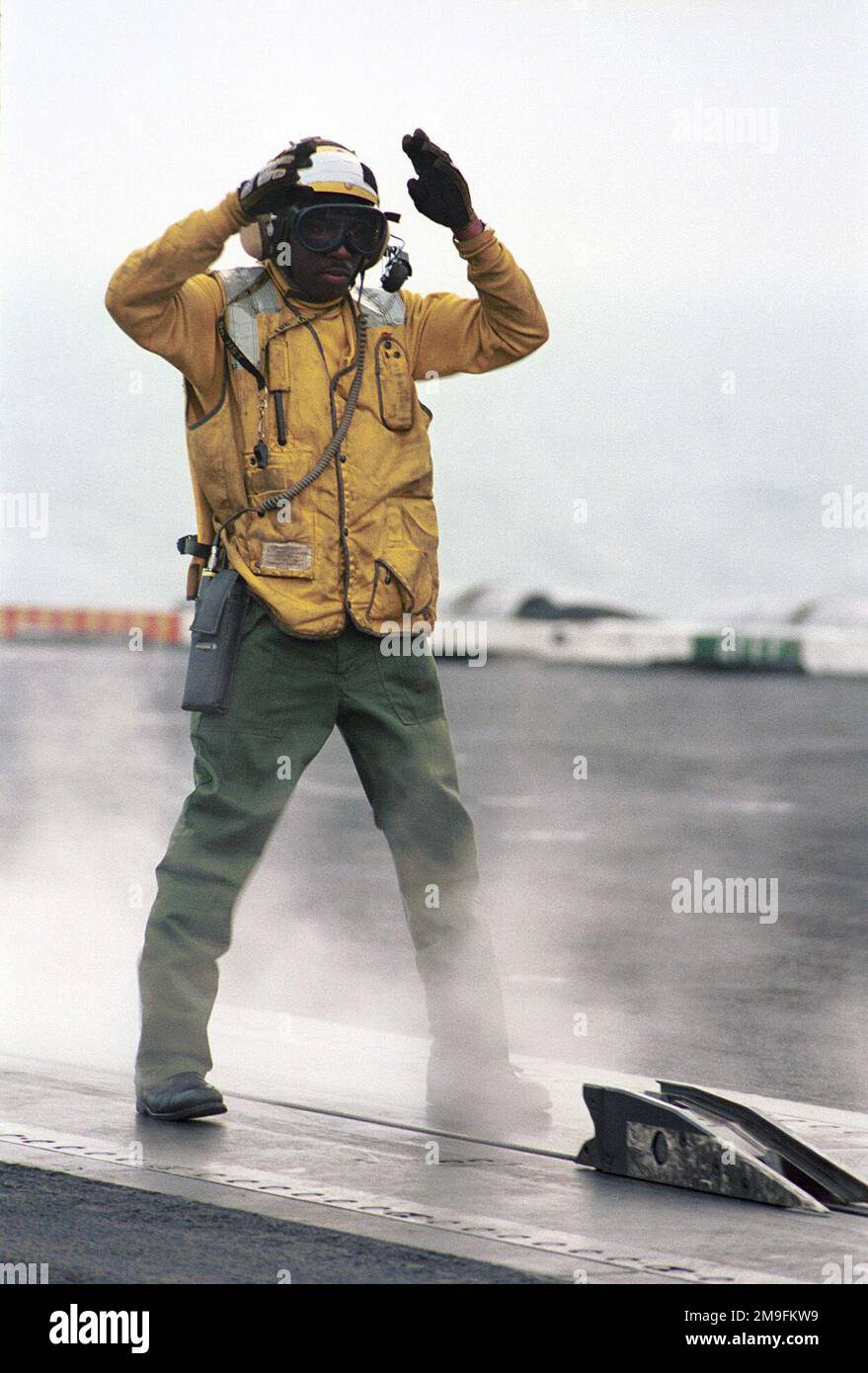 US Navy Aviation Boatswain's Mate Third Class Richard Cambell directs ...