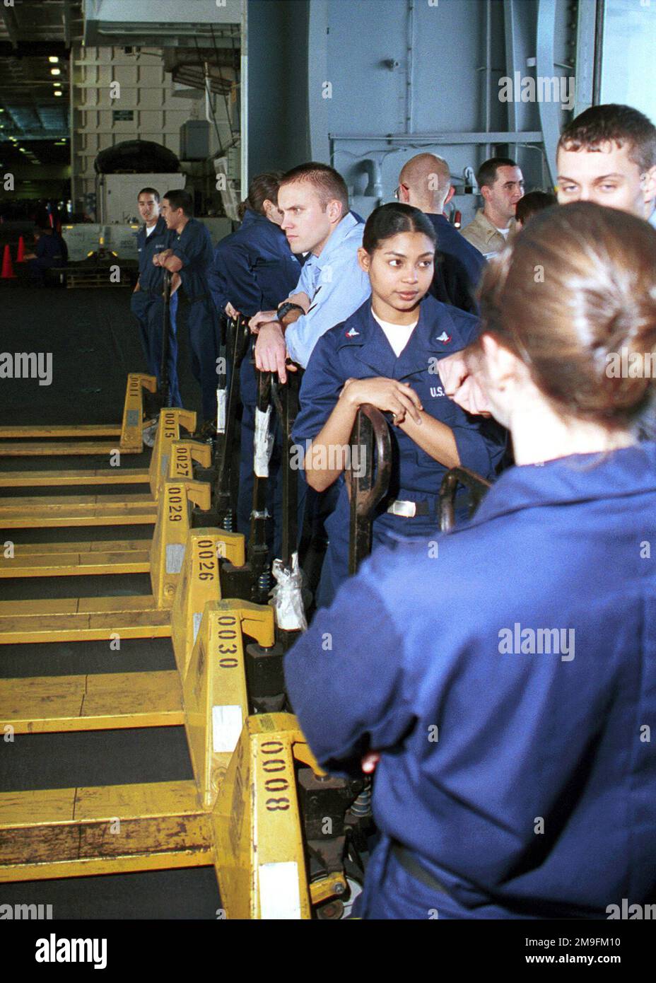 Crew members onboard USS HARRY S. TRUMAN (CVN 75) stand by for further ...