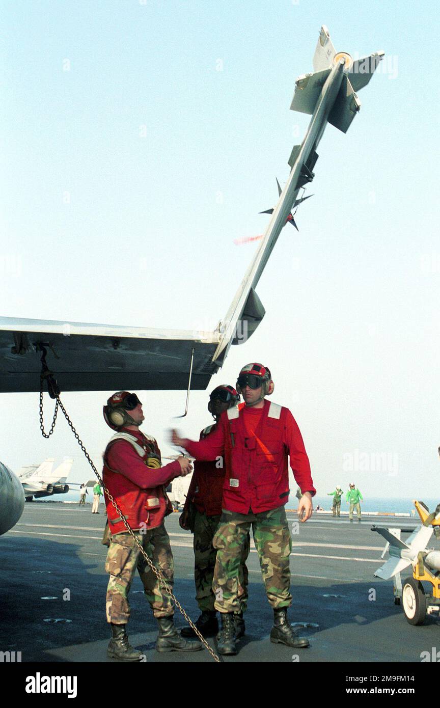 Marines from Marine Fighting Squadron Three Twelve (VMFA 312) hand ...