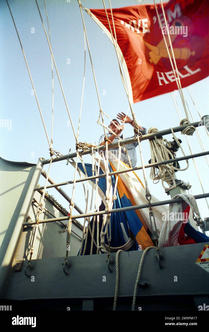 US Navy Signalman Third Class Justin Hanshew raises USS HARRY S. TRUMAN ...