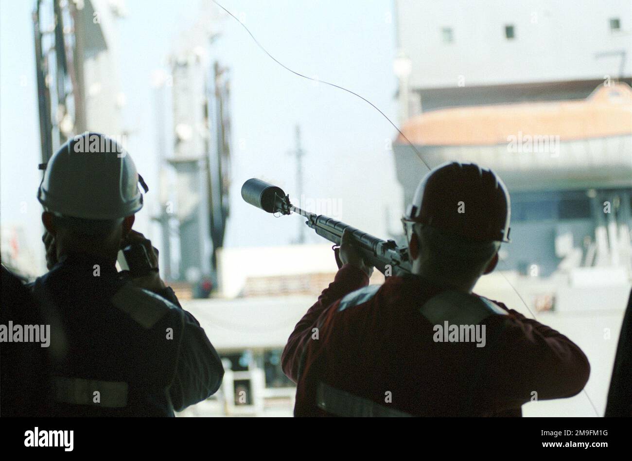 USS HARRY S. TRUMAN (CVN 75) GUNNER's Mates fire a securing line to ...