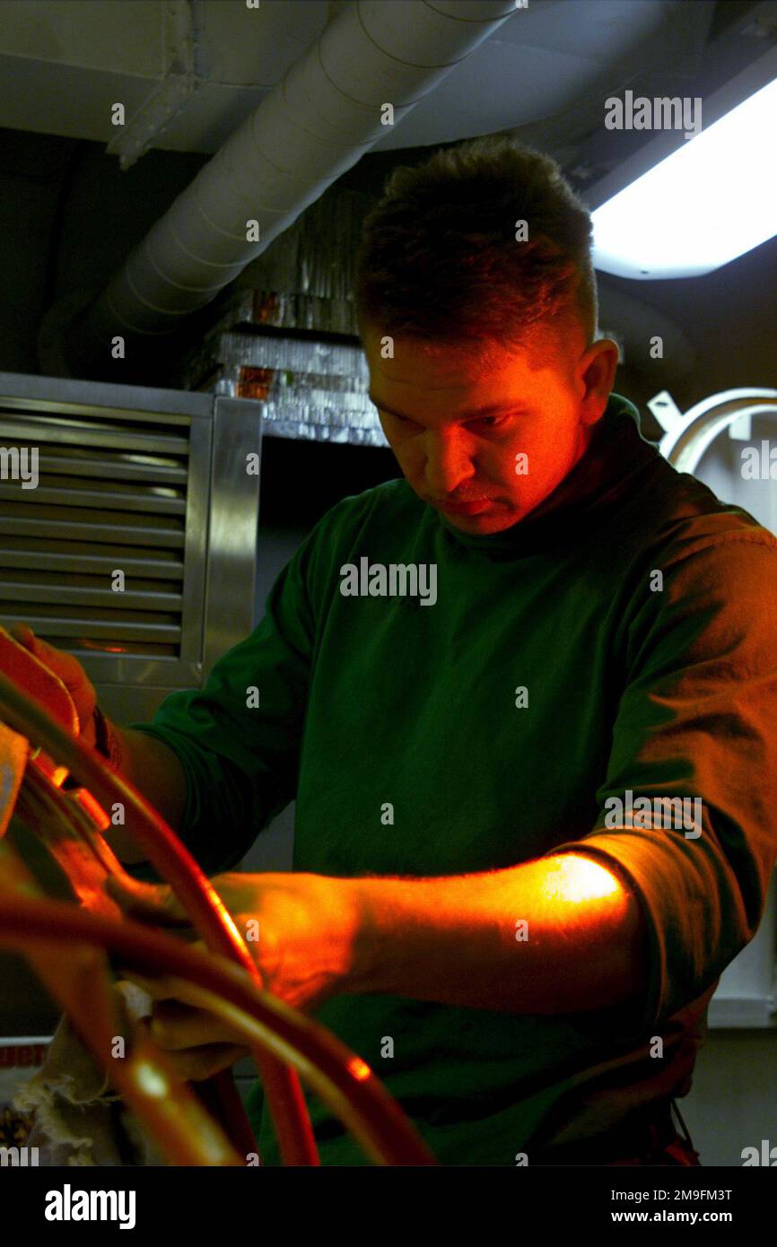 US Navy Aviation Structural Mechanic AIRMAN Carl Billings sands the ...