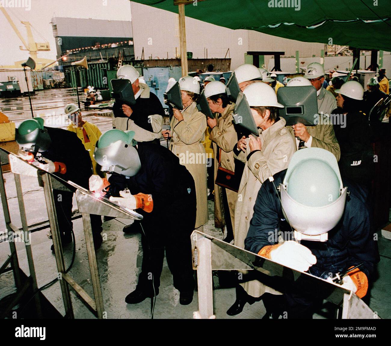 Welders make the first marking cuts during the keel laying ceremony for ...