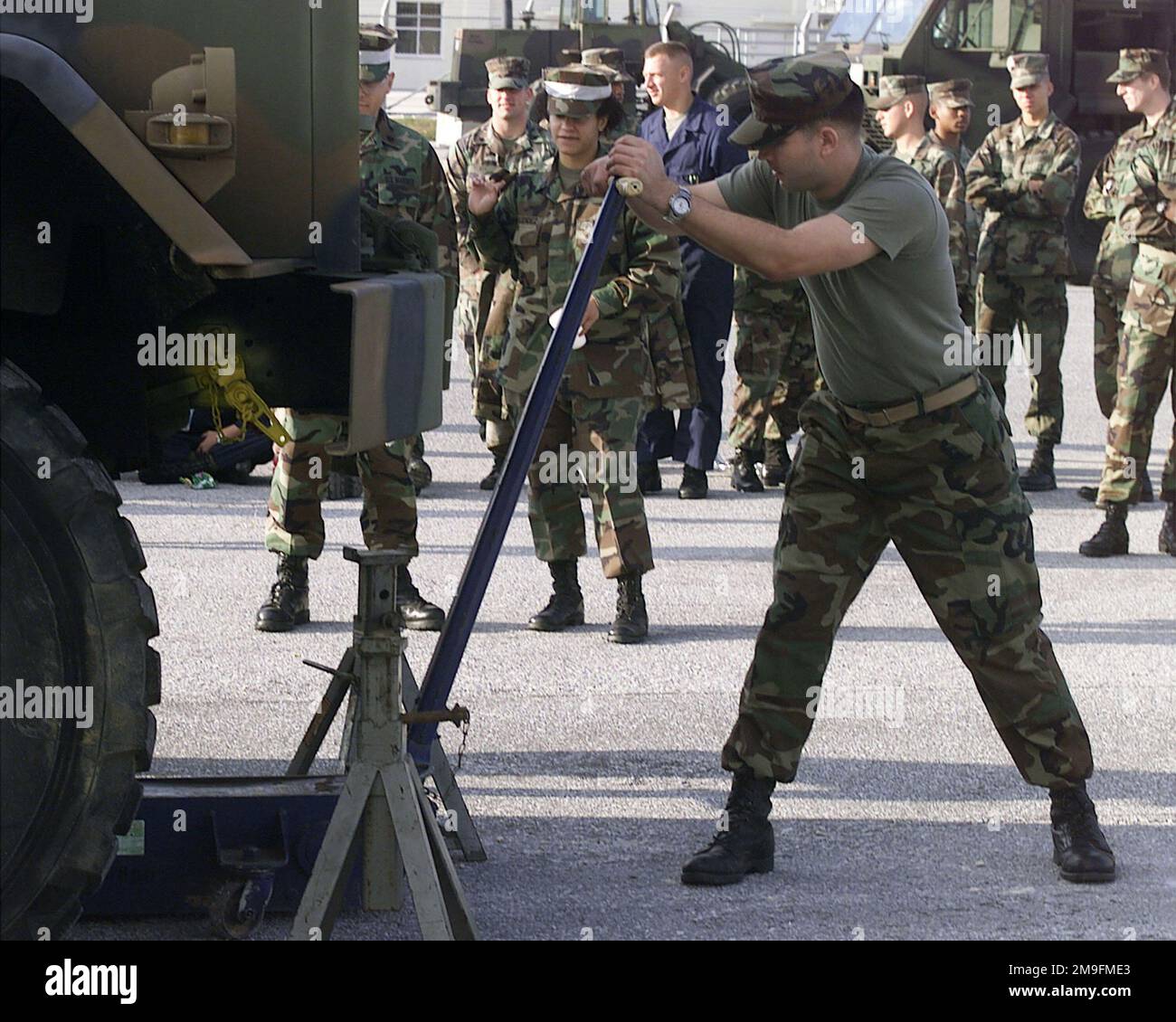 Corporal Daric J. Zeckzer from MACG-36, jacks up an M913 5-ton truck ...
