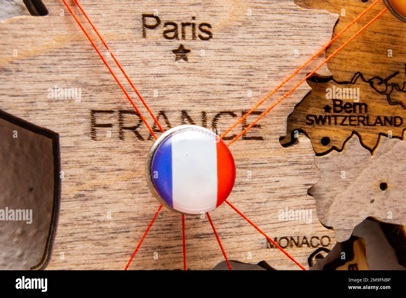 France flag on the pushpin with red thread showed the paths of movement ...