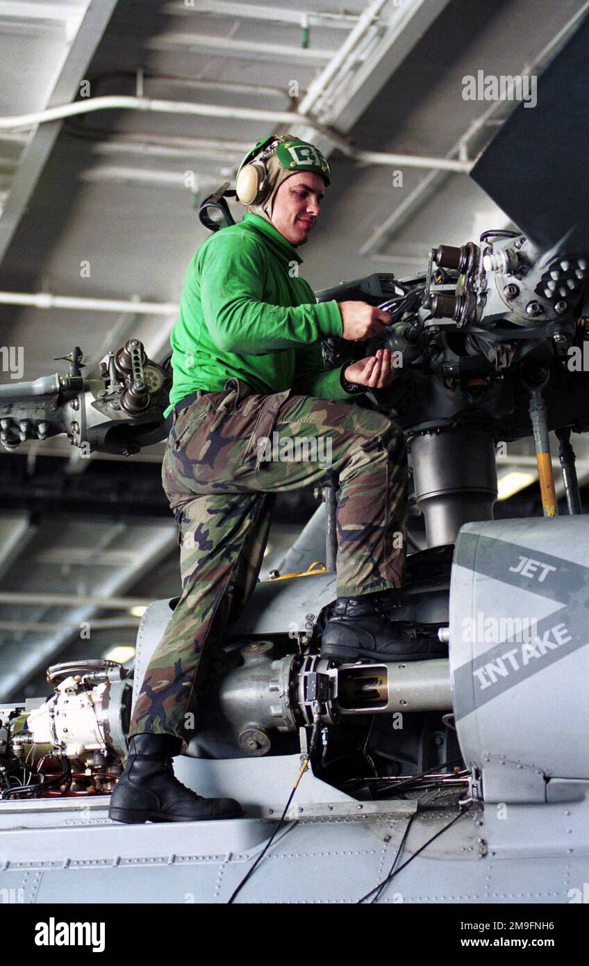 Aviation Structural Mechanic AIRMAN Jason Severson tightens the bolts ...