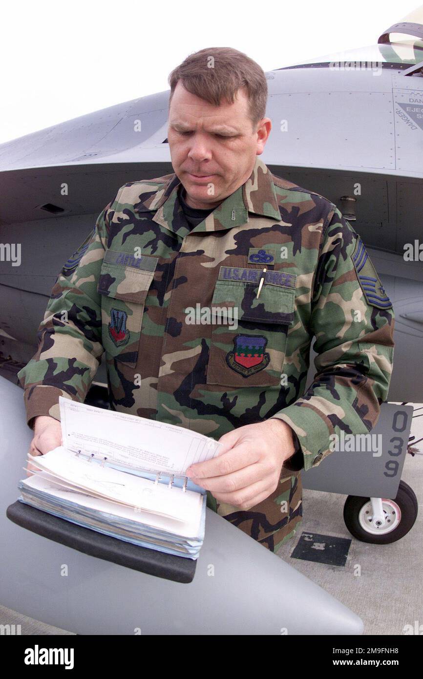 US Air Force CHIEF MASTER Sergeant Carey Castle looks over a checklist ...