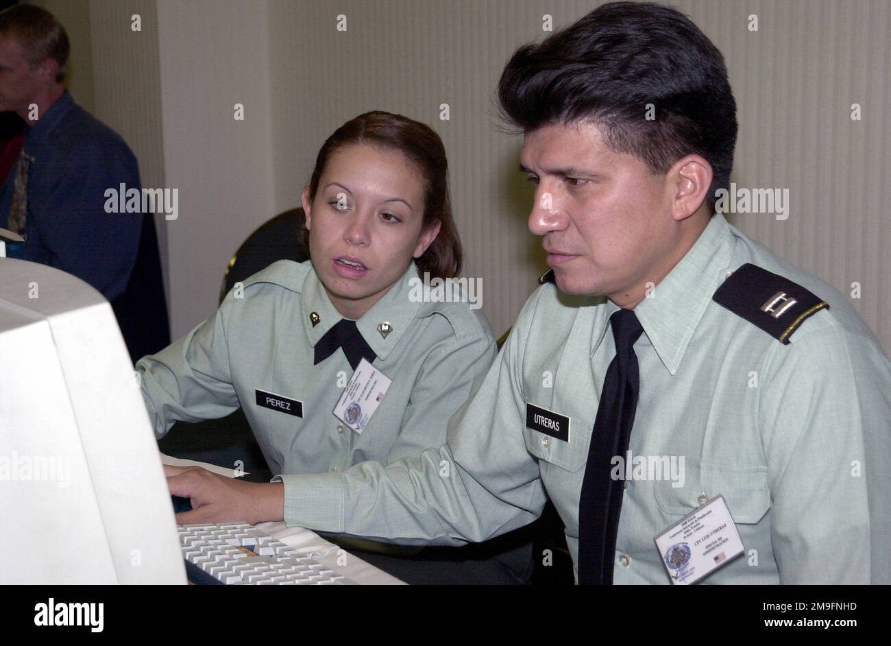 Captain Luis Utreras, US Army South Admin officer, right, helps out ...