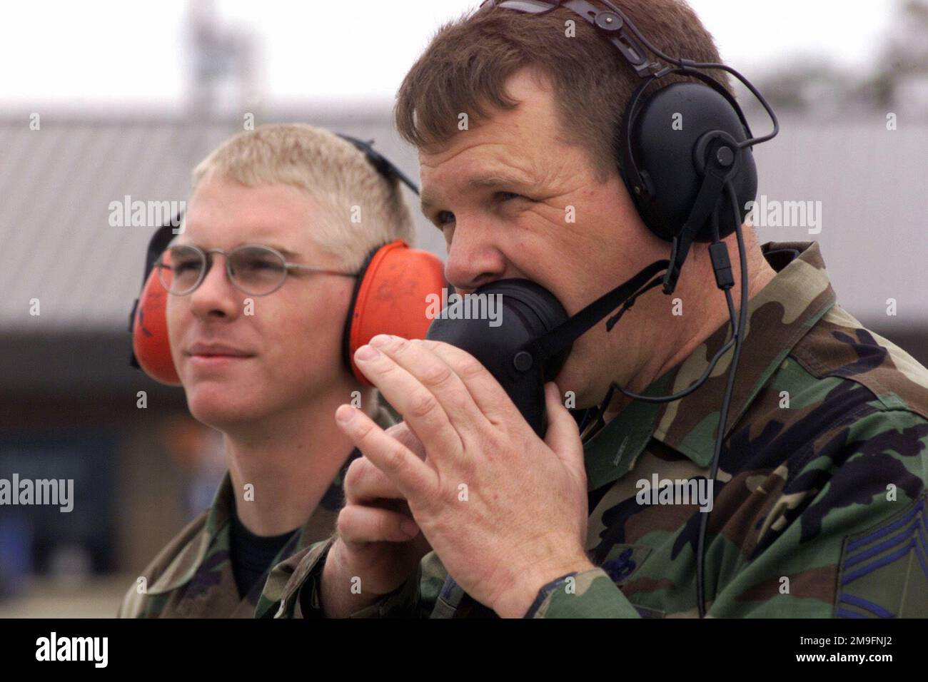 US Air Force CHIEF MASTER Sergeant Carey Castle (right) talks into the ...