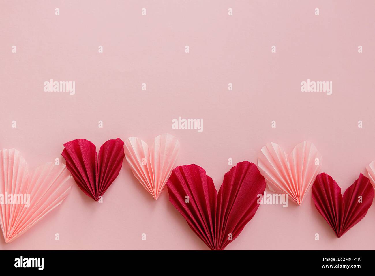 Happy Valentine's day! Stylish red and pink hearts flat lay on pink ...