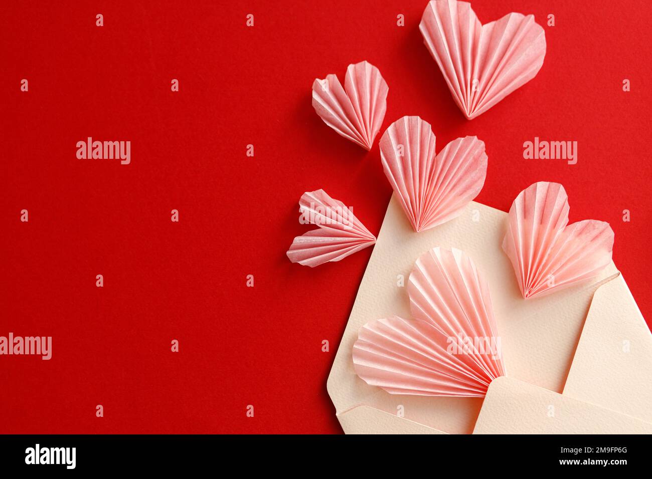 Happy Valentine's day! Stylish envelope with pink hearts flat lay on ...