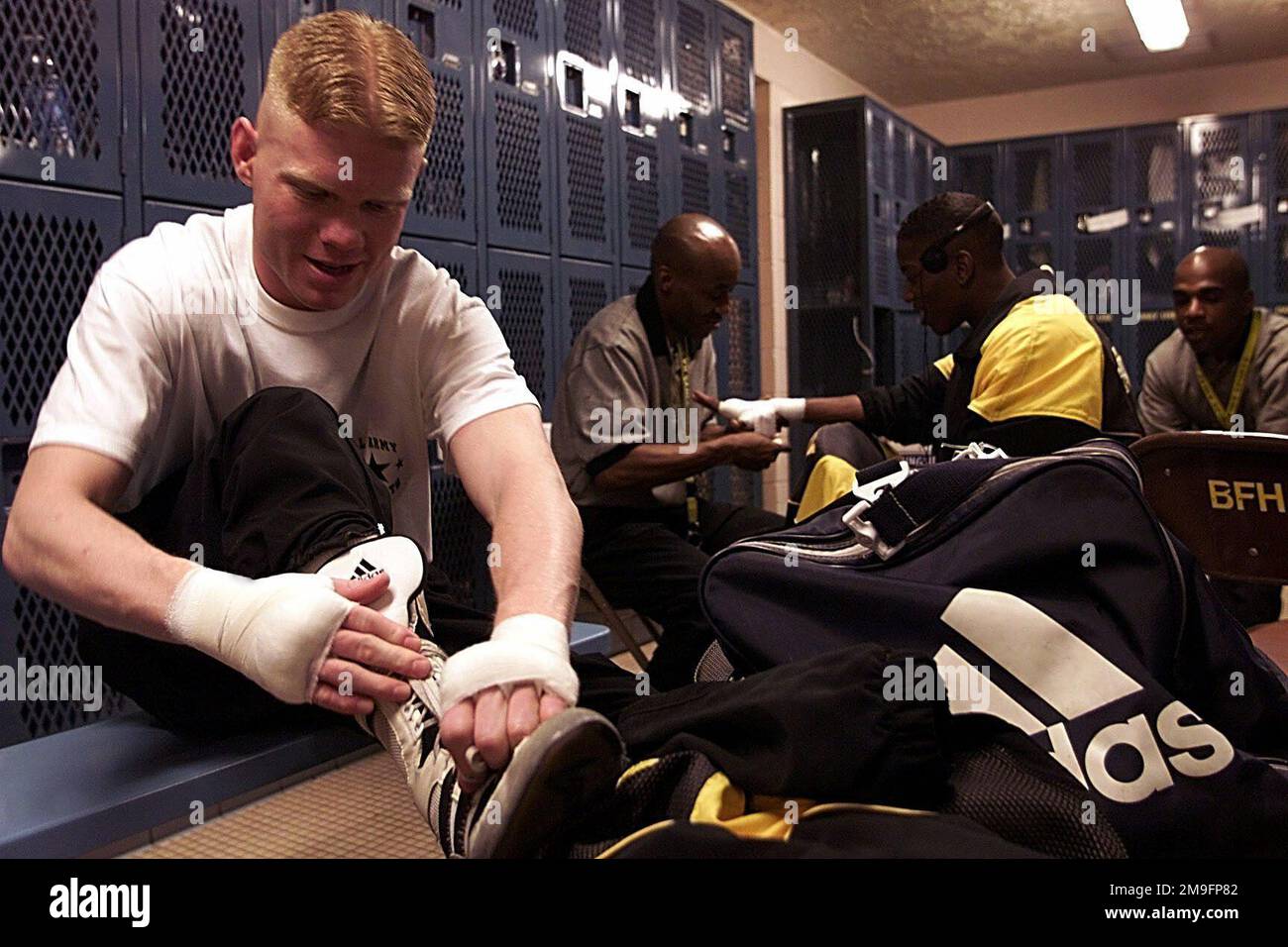 US Army boxer Sergeant Marshall Christmas (Left) ties his shoe laces ...