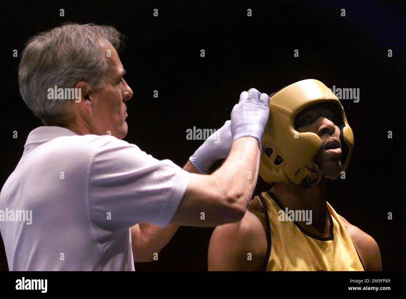 US Navy boxer Deano Jenkins (Right) has his protective head gear ...