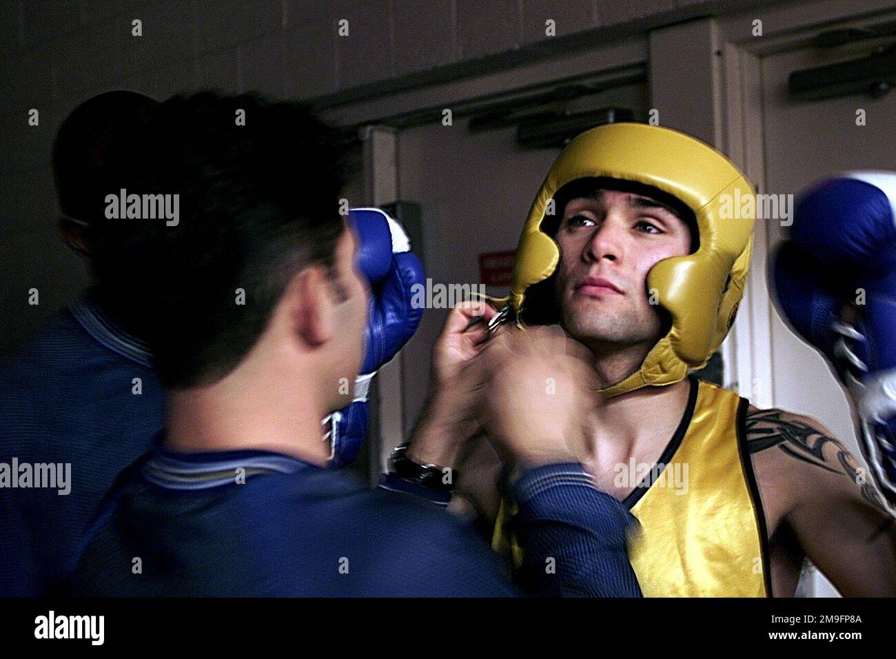 US Navy Boxer Charles Morales dons his protective head gear prior to ...
