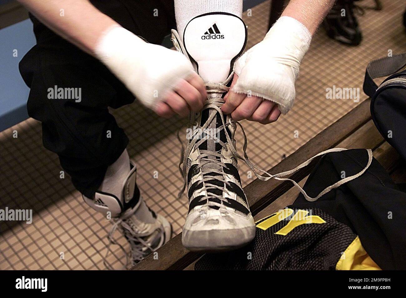US Army boxer Sergeant Marshall Christmas ties his shoe laces and ...
