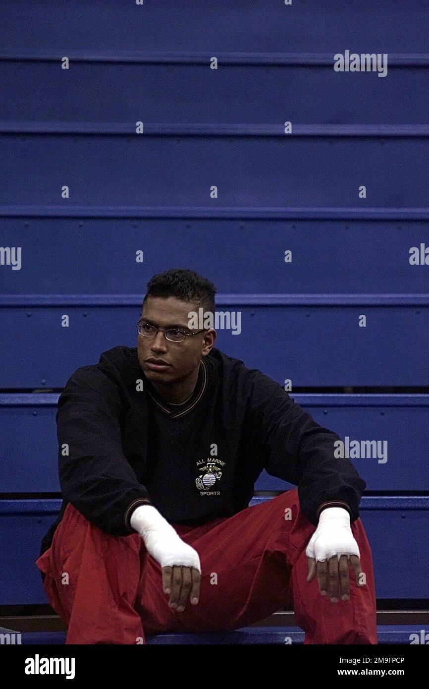 A member of the US Marine Corps boxing team relaxes before his boxing ...