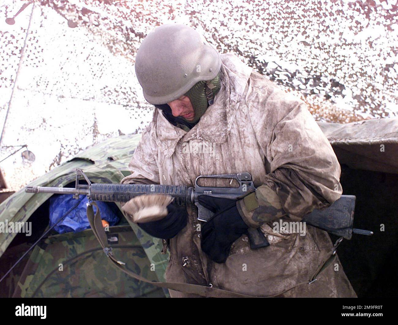Lance Corporal Richard Colletta performs weapons maintainence on his ...