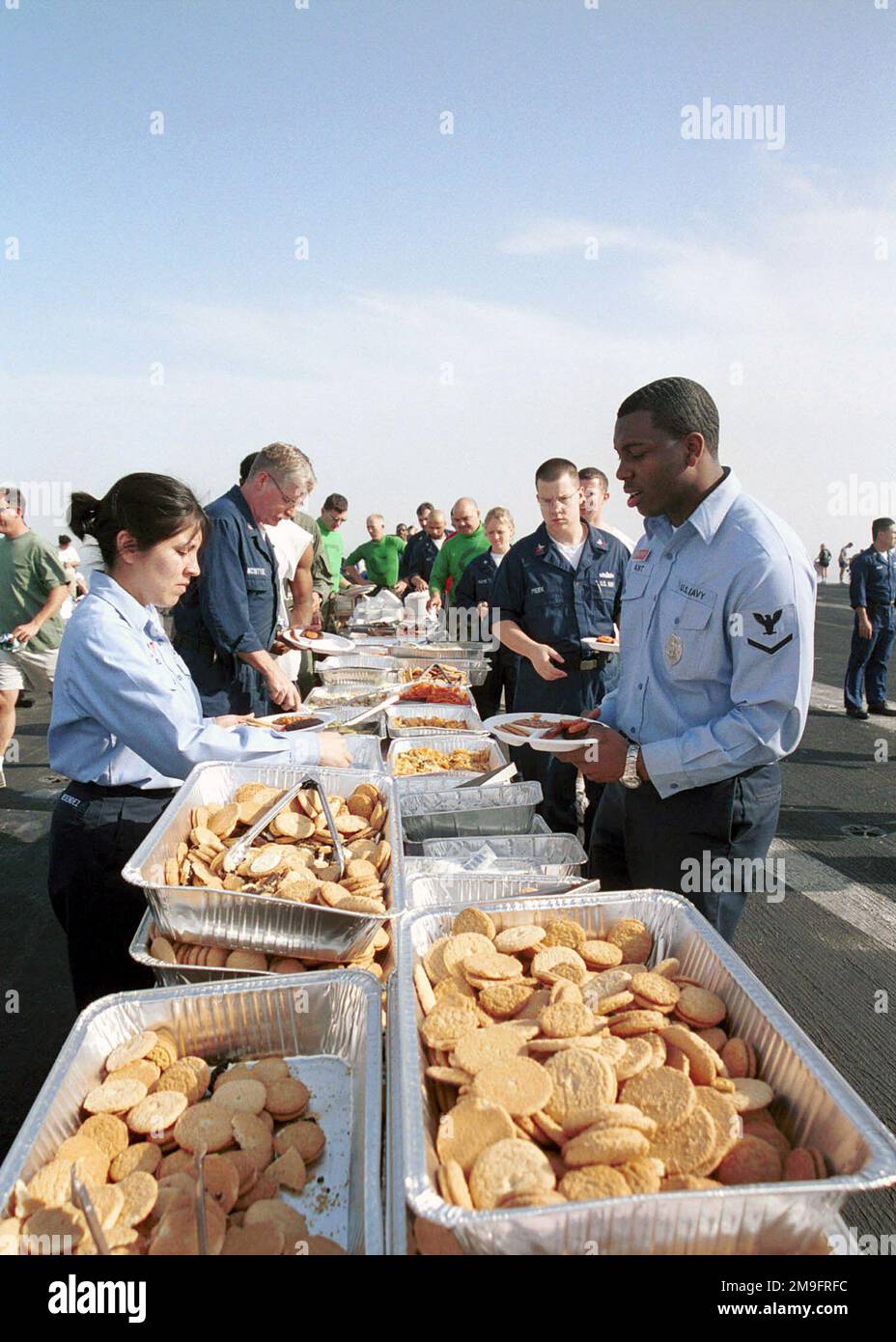 Sailors enjoy a barbecue buffet at a steel beach picnic held on the ...