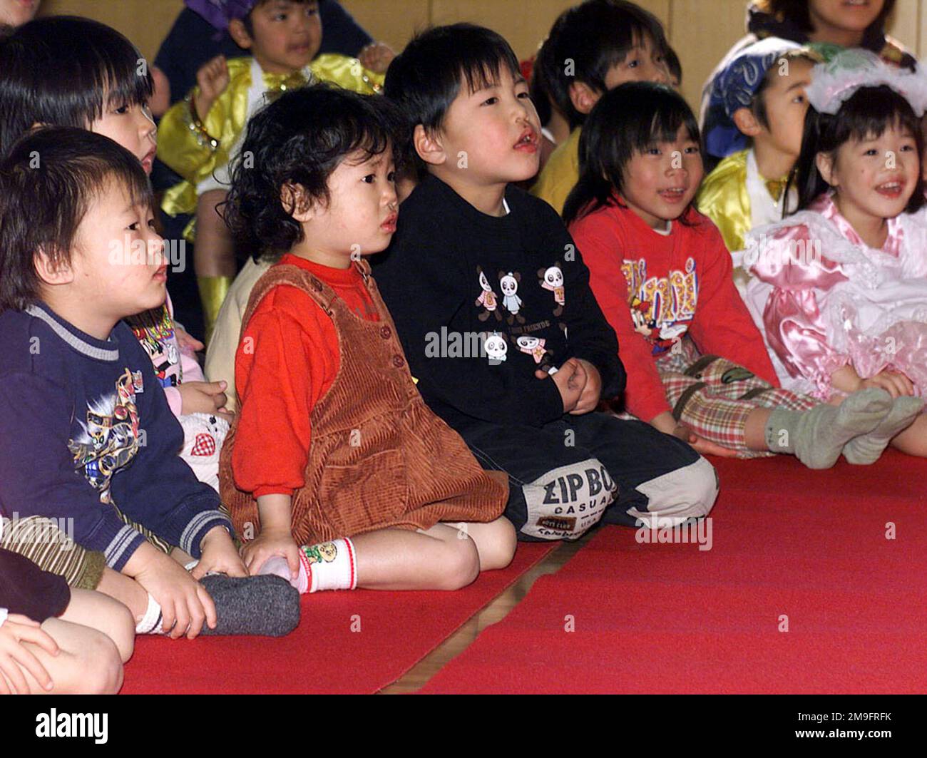 Japanese orphans watch the performance of US Marine Lance Corporal ...