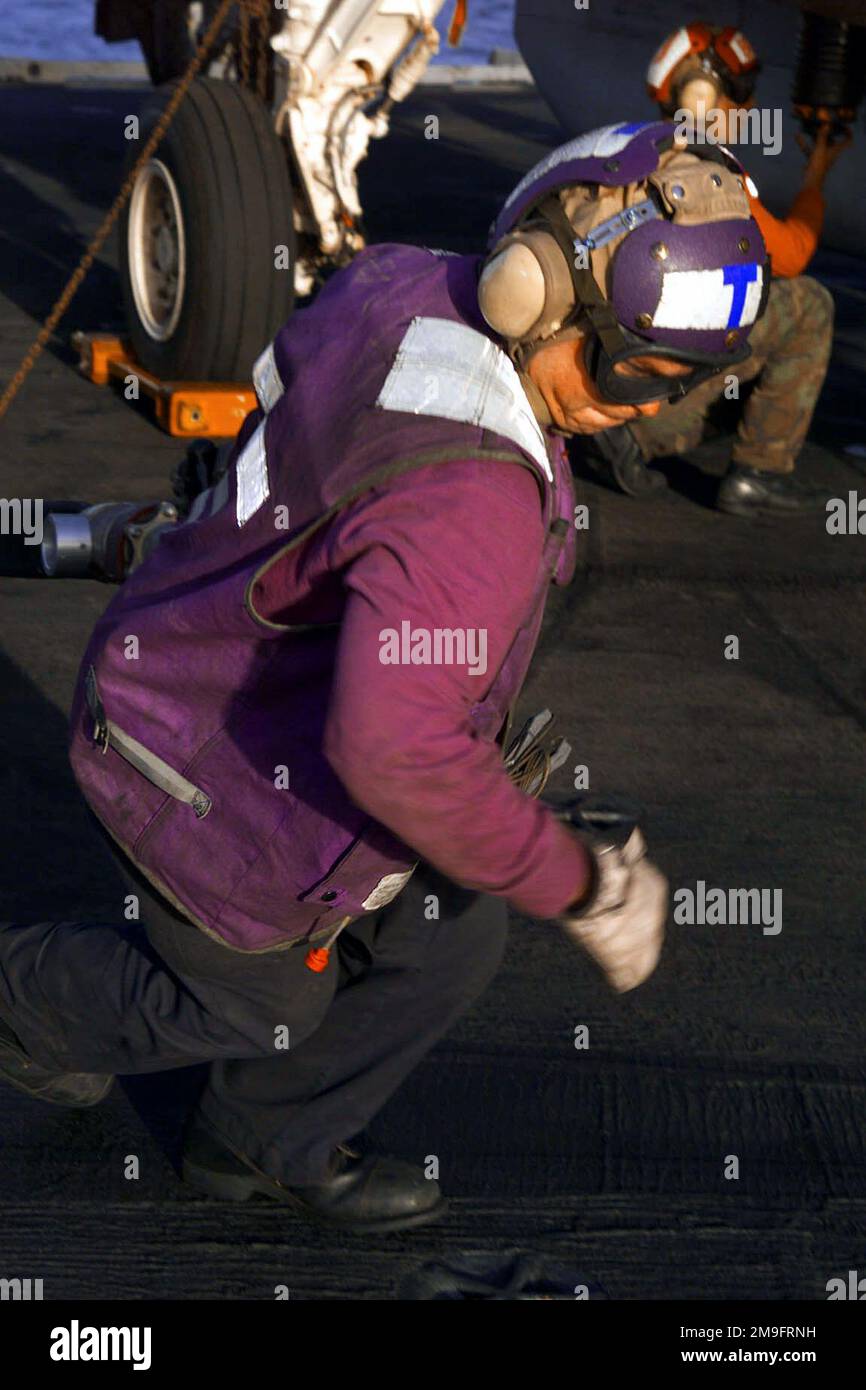 US Navy AIRMAN Apprentice Charles Hines pulls a JP-5 fueling hose ...