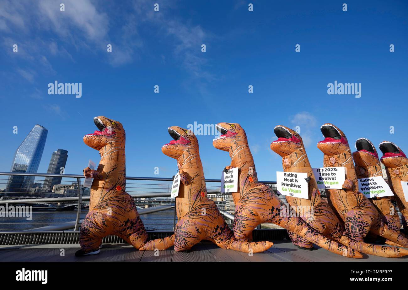 PETA (People for the Ethical Treatment of Animals) supporters dressed in dinosaur costumes with ...