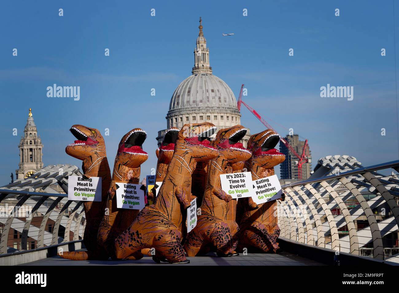PETA (People for the Ethical Treatment of Animals) supporters dressed in dinosaur costumes with ...