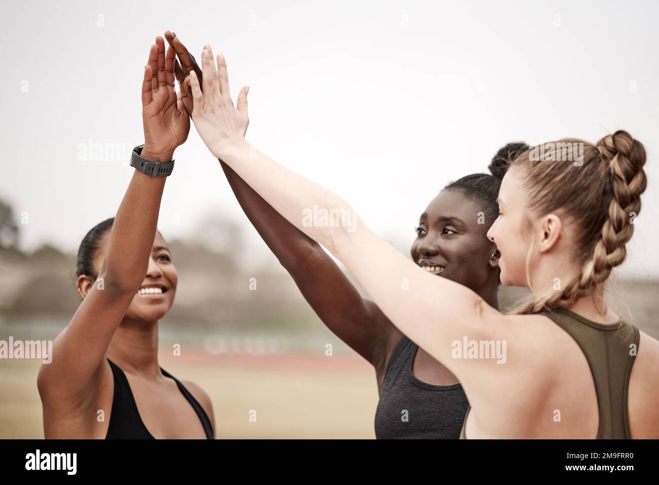 Believe in your abilities. a group of female athletes high fiving one ...
