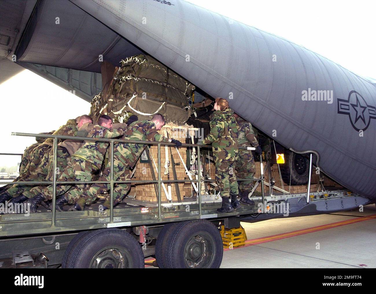 Members of the 173rd Airborne Brigade, Vicenza, Italy, load cargo onto ...