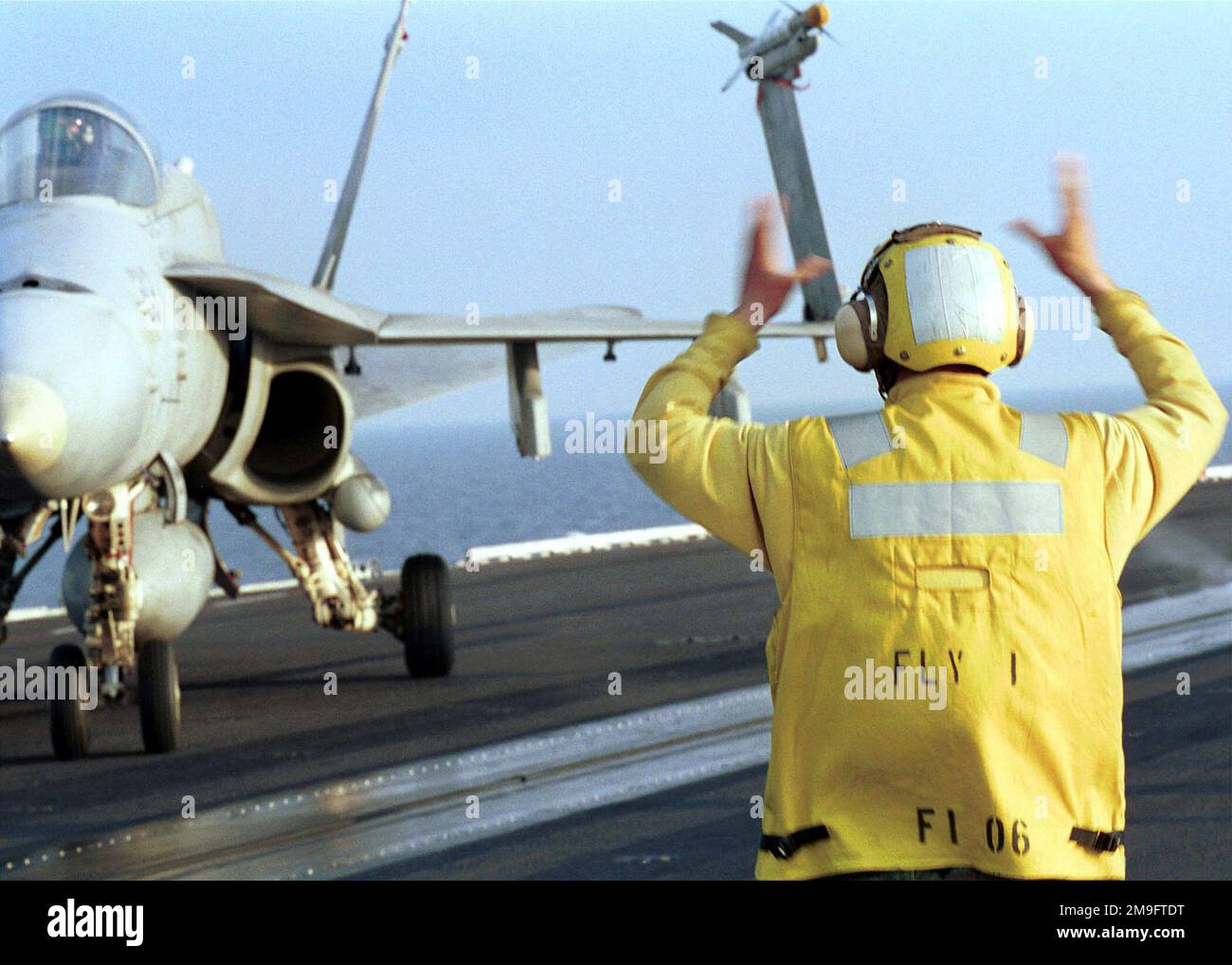 US Navy Aviation Boatswain's Mate (Handler) AIRMAN Ethan Lane parks an ...