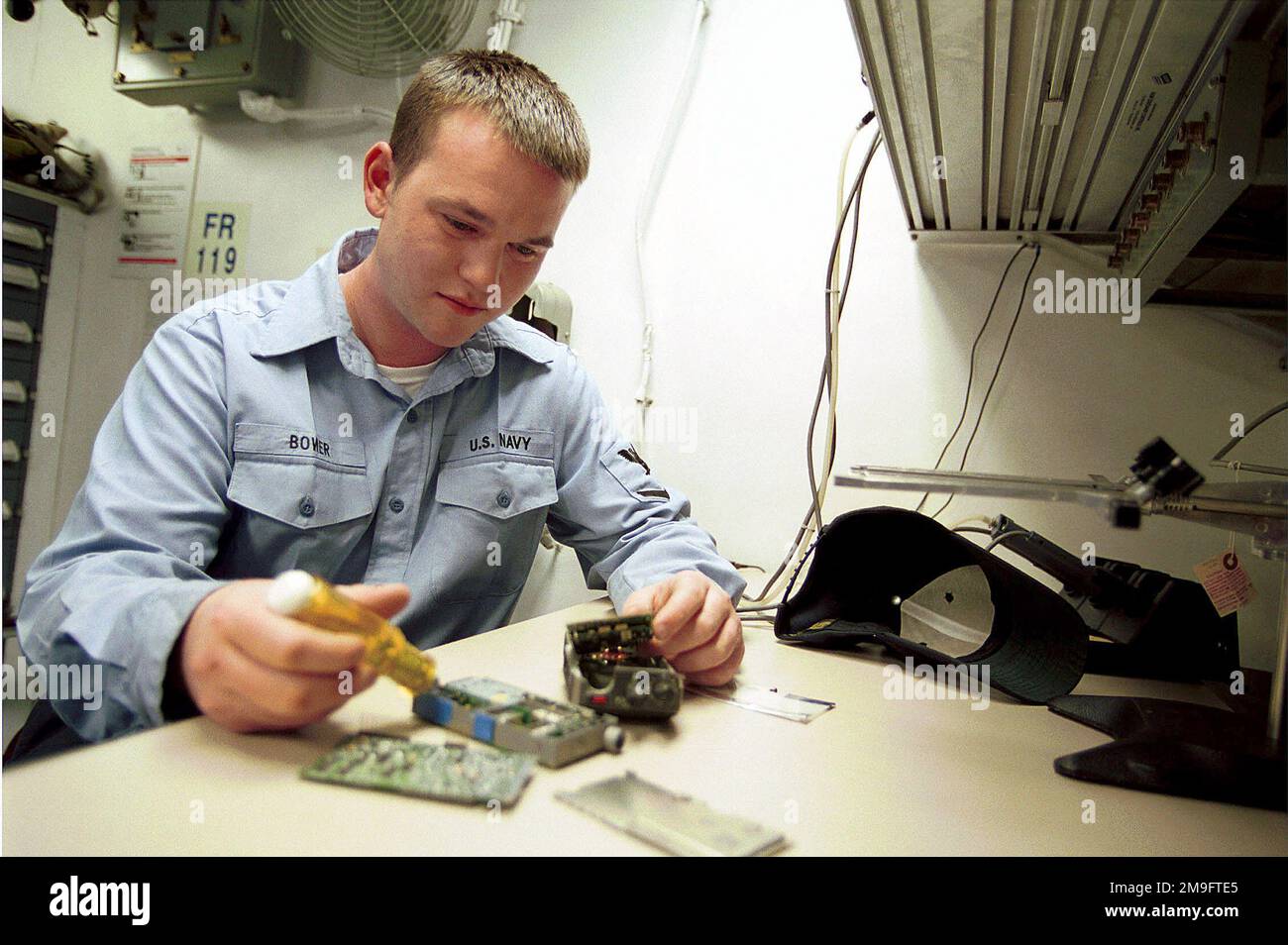 US Navy Electronics Technician Third Class David Bower repairs a hydra ...
