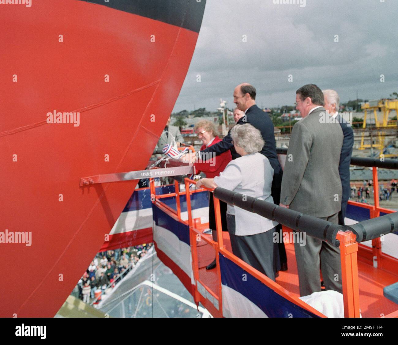 As member of the christening party look on, Mrs. Arlene May Pomeroy ...