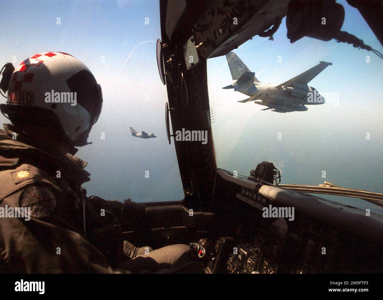 Lieutenant Commander Chris "Ward" Schenck keeps an eye on surrounding S ...