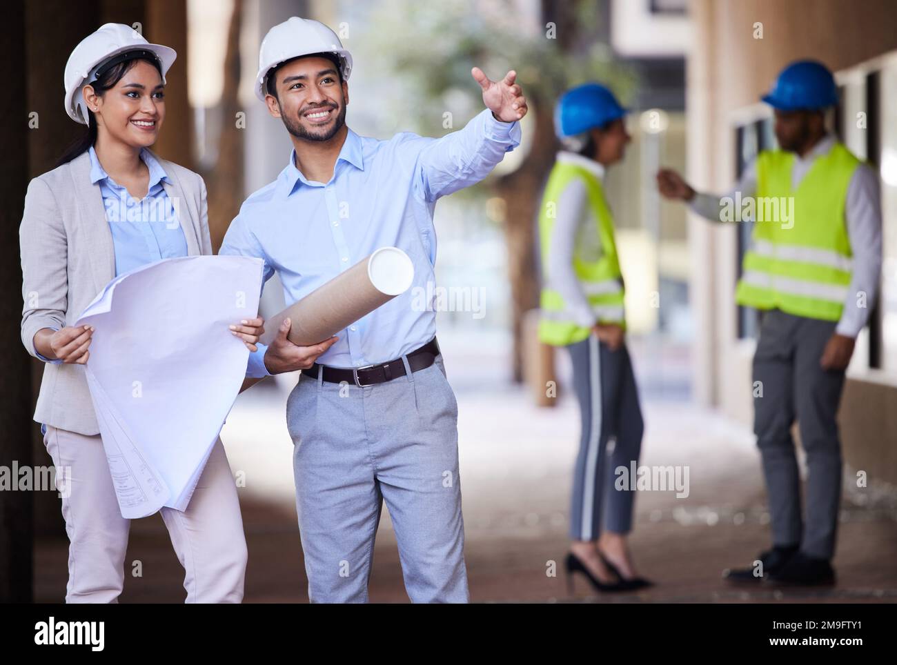 Were going to build right here. two young architects standing together ...