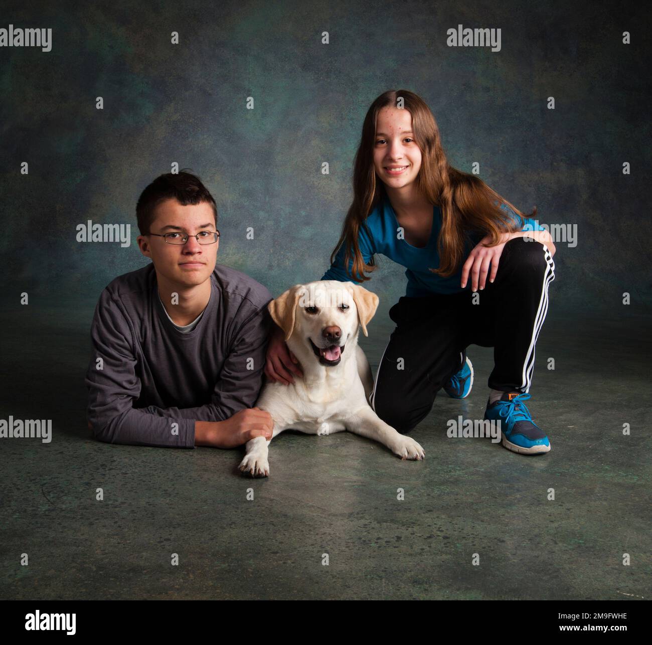 Portrait of Labrador with owners Stock Photo - Alamy